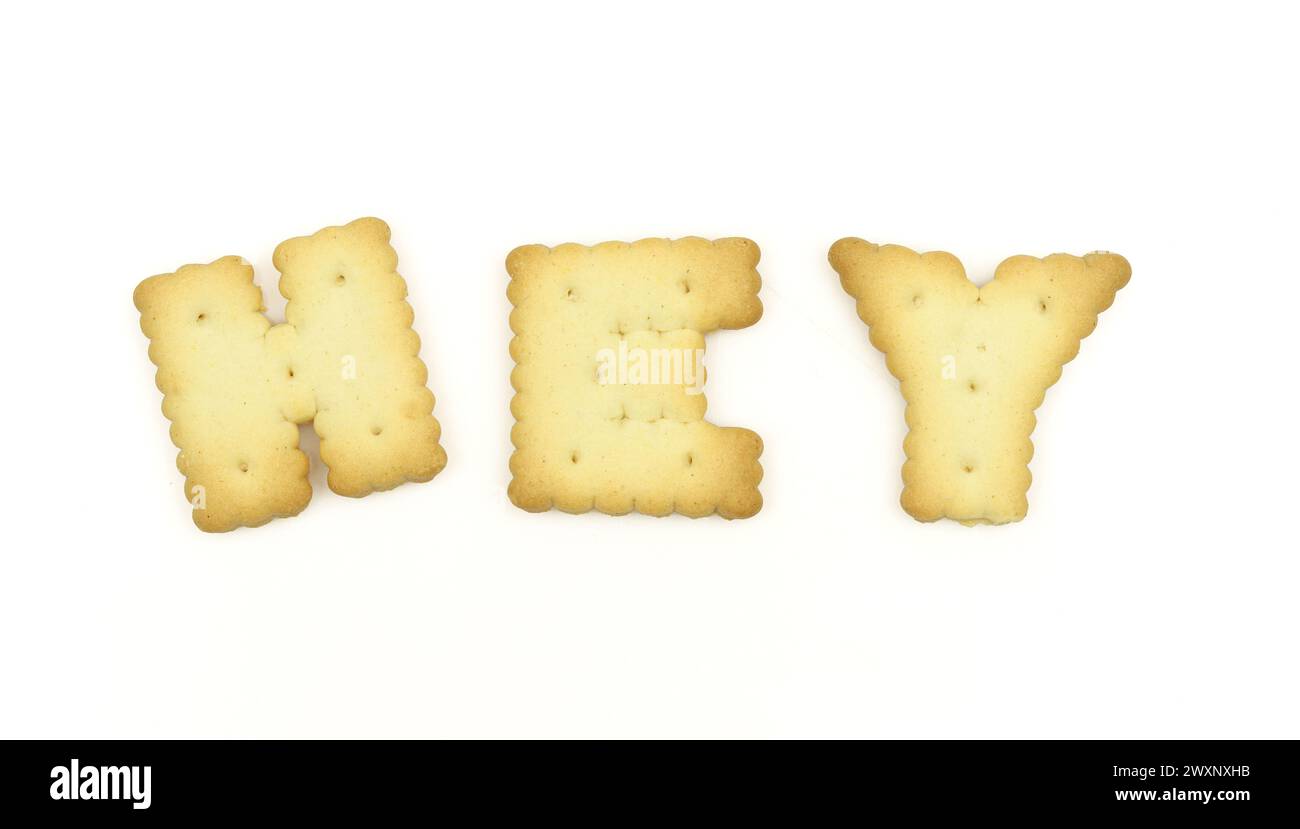 Capital letter shaped biscuits forming word HEY isolated on white ...