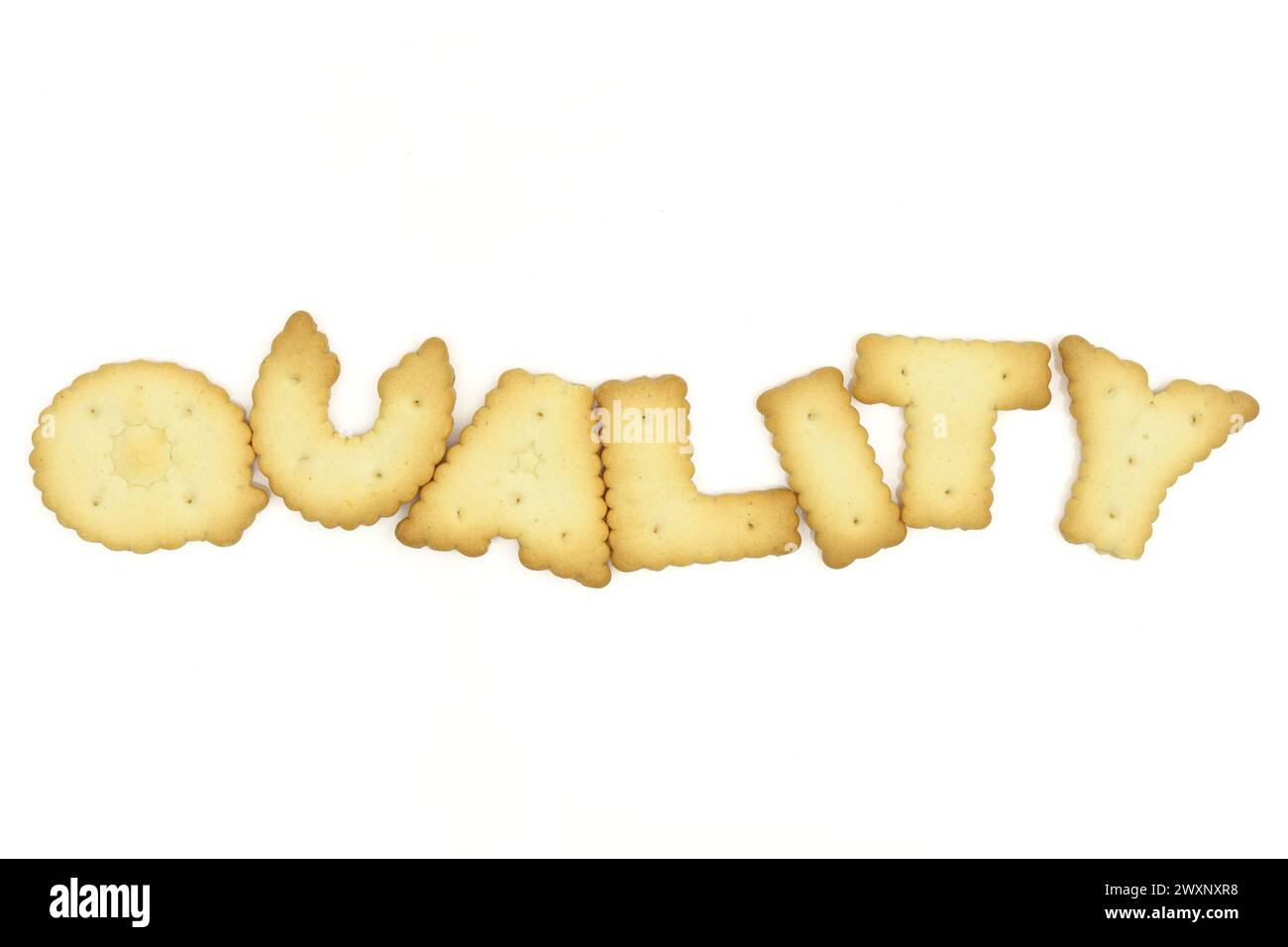 Capital letter shaped biscuits forming word QUALITY isolated on white ...