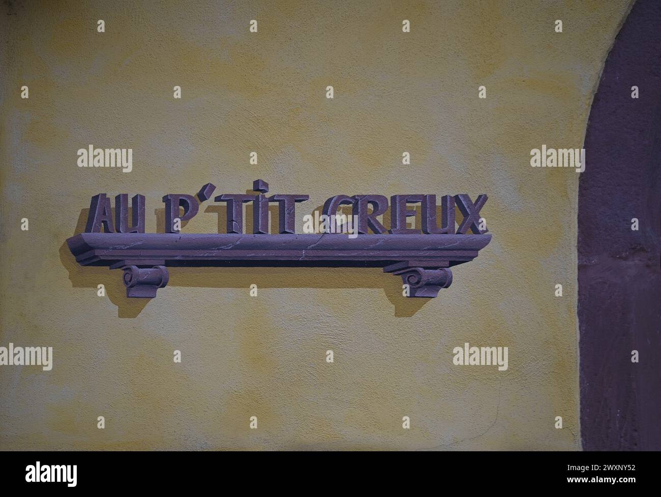 "Au P'Tit Creux" a hand painted sign written in French of a local pizza ...