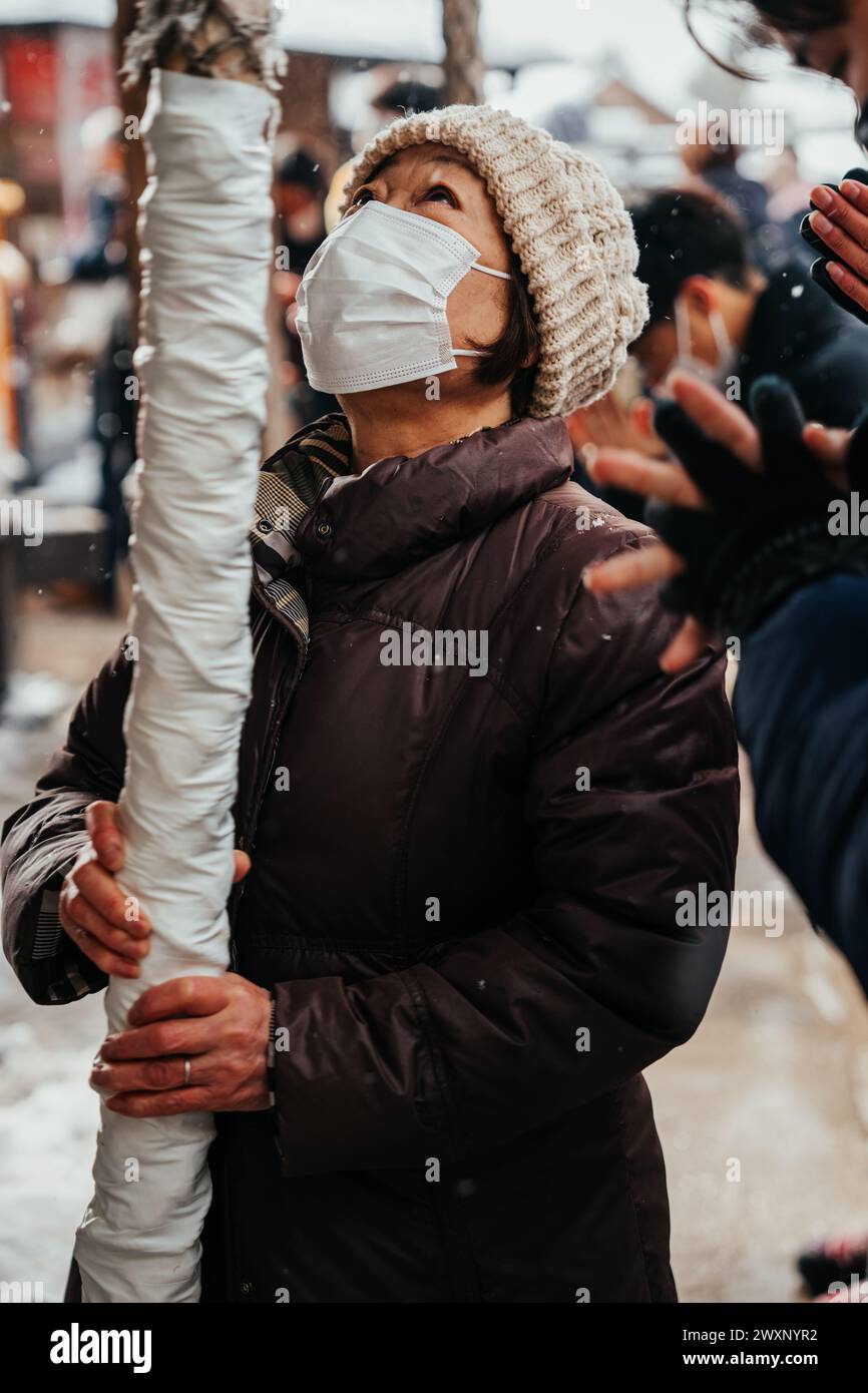 The Worshipers at a a rare snow covered Buddhist temple at Kinkaku Ji ...