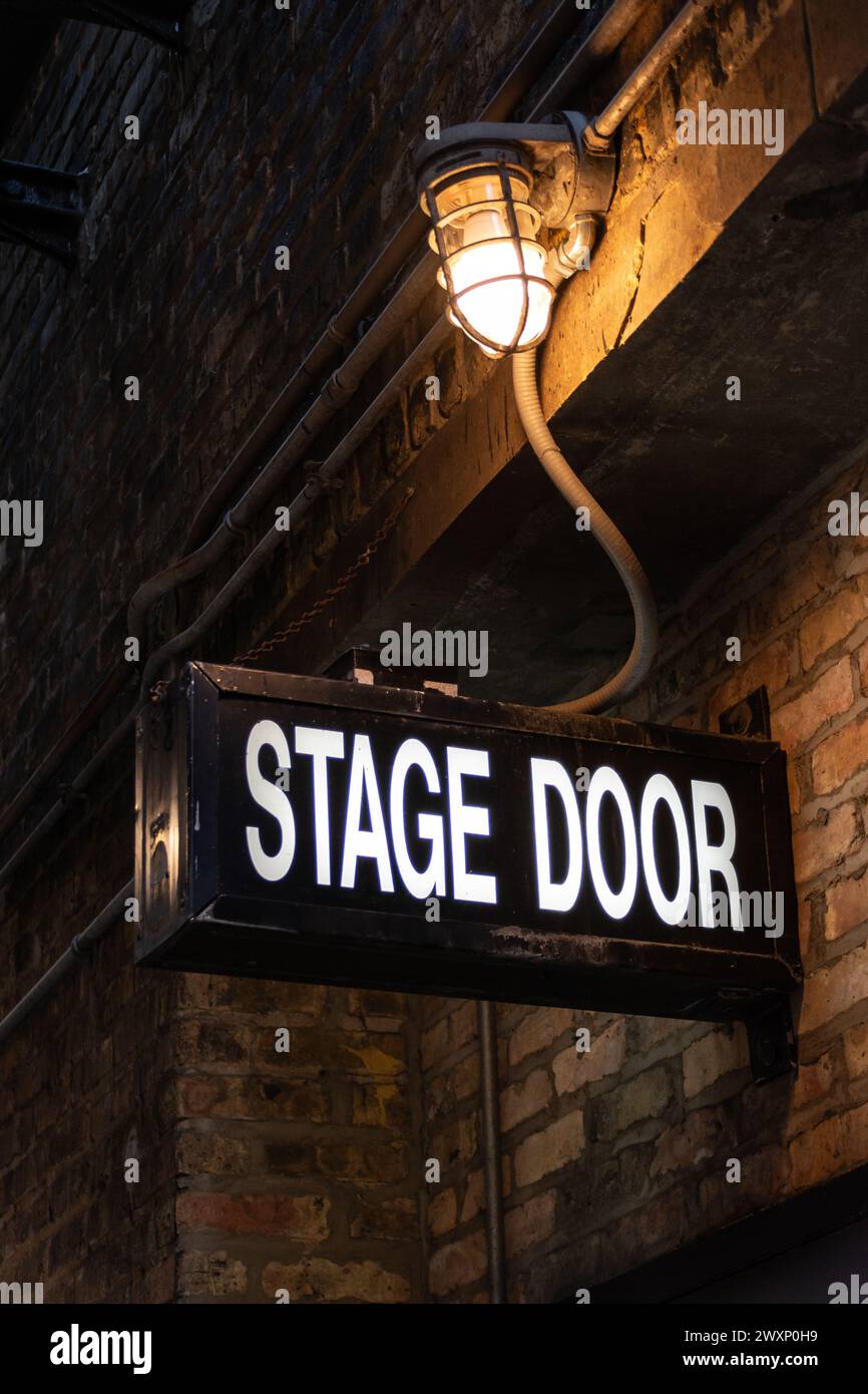 Vintage illuminated stage door sign in a dark and dingy back alley in ...