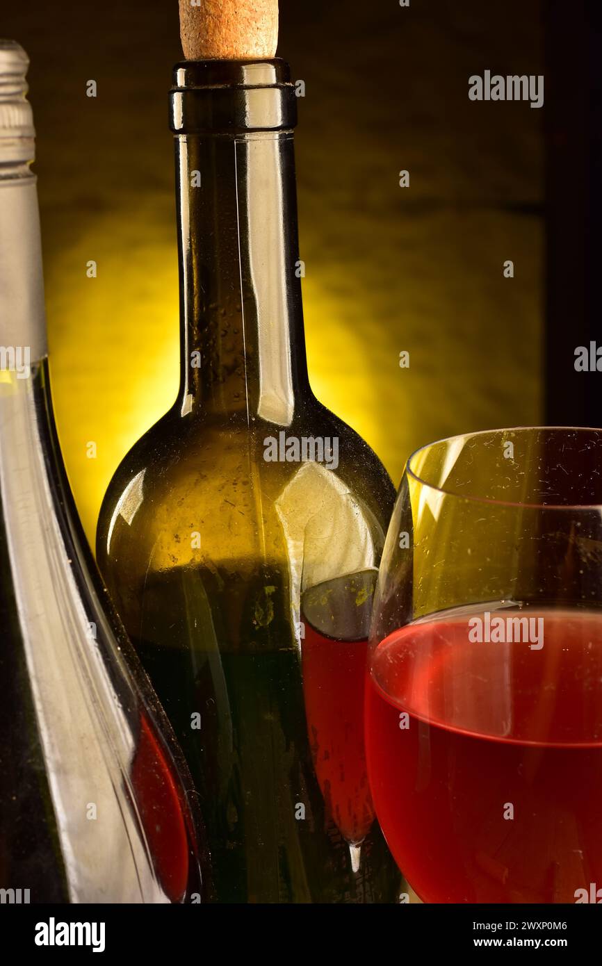 Glass and bottle of wine on yellow background Stock Photo - Alamy