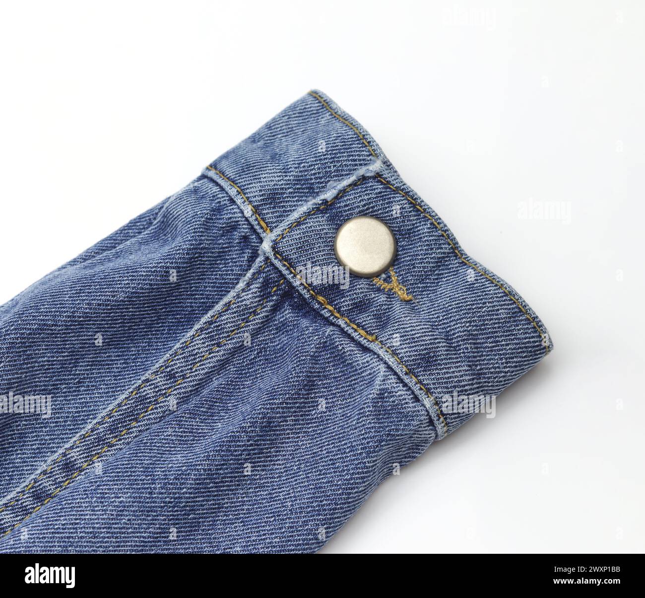Metal button on top of jeans jacket sleeve isolated on white background ...