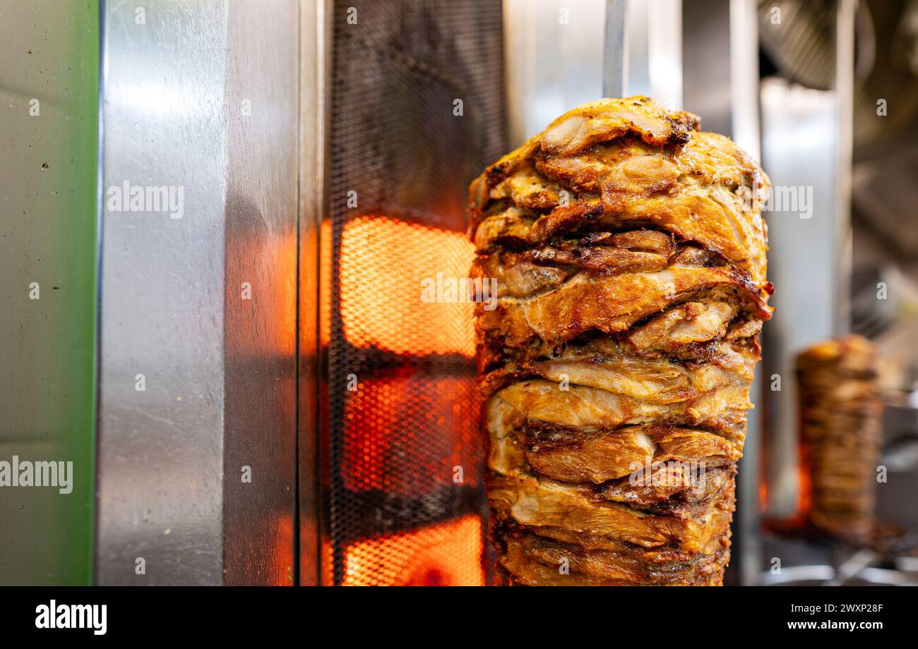 Juicy meat is fried on a shawarma spit Stock Photo - Alamy