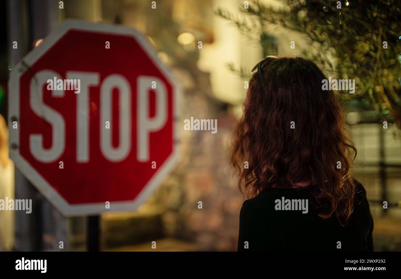 The girl stopped at a stop sign Stock Photo - Alamy