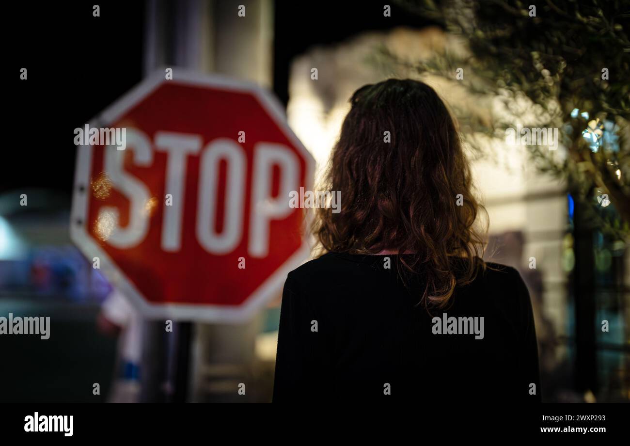 The girl stopped at a stop sign Stock Photo - Alamy