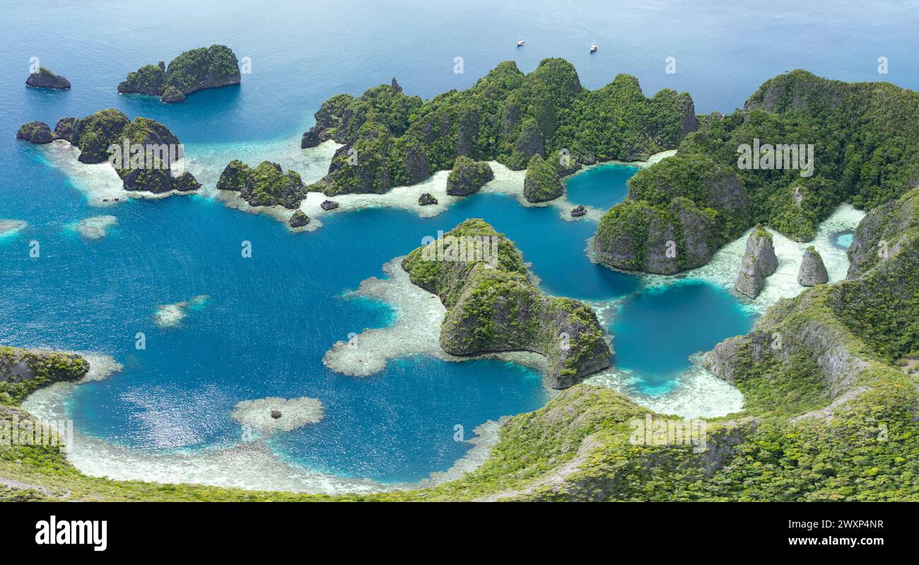 The limestone islands of Balbalol, fringed by reef, rise from Raja ...