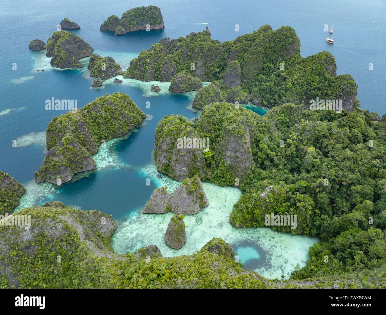 The limestone islands of Balbalol, fringed by reef, rise from Raja ...
