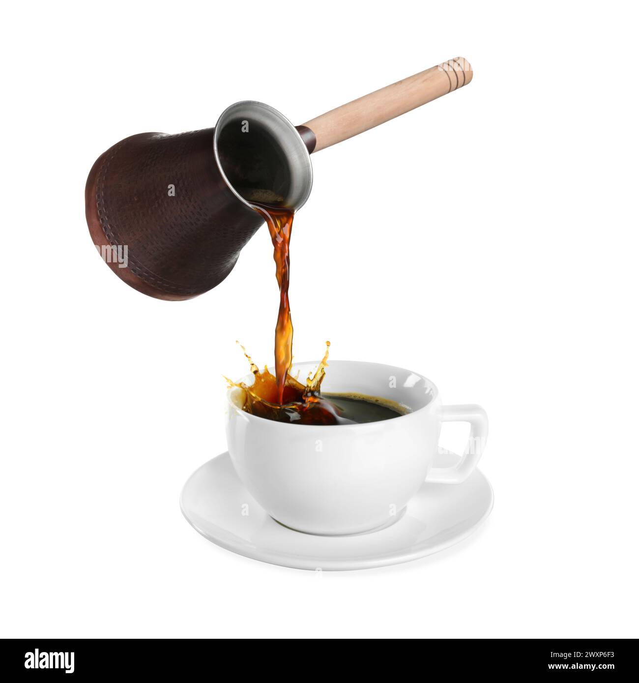 Pouring freshly brewed aromatic coffee from turkish pot into cup ...