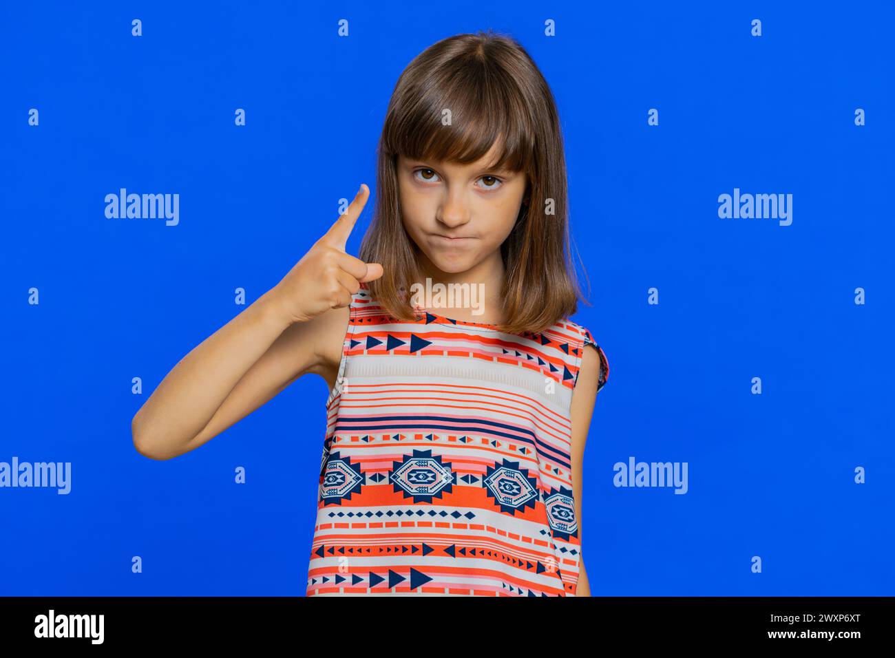 Quarrel. Displeased young cute brunette school girl gesturing hands ...