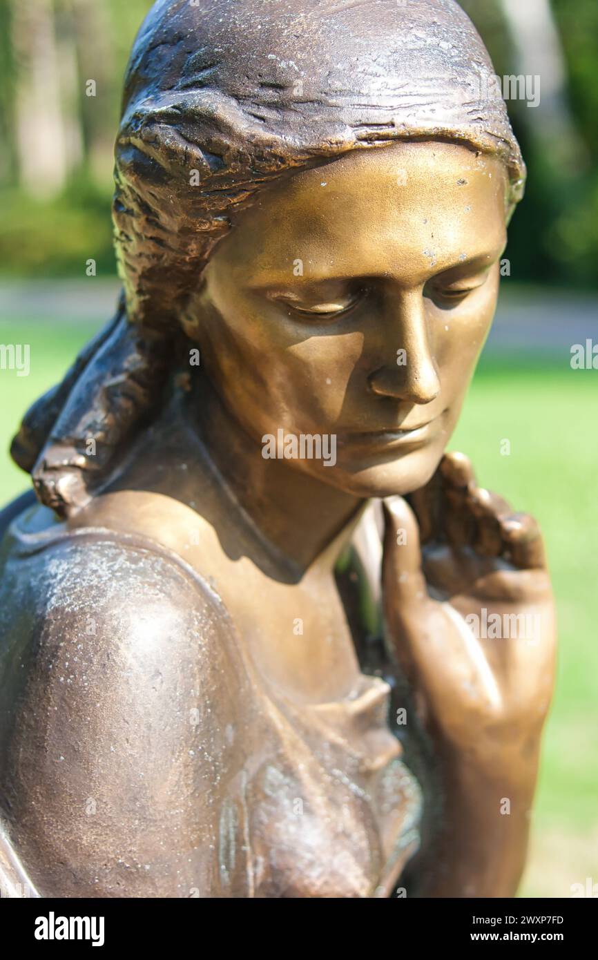 A solitary female statue in the cemetery embodies sadness and mourning ...