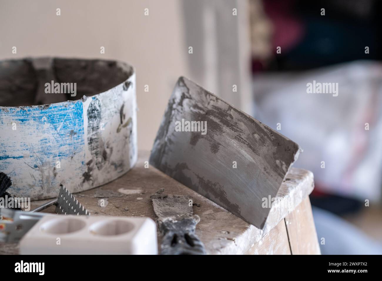 Applying decorative putty. White abstract texture of surface covered ...