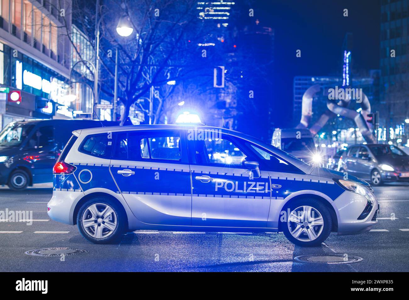 German police car waiting on the road and arranging traffic. Police car ...