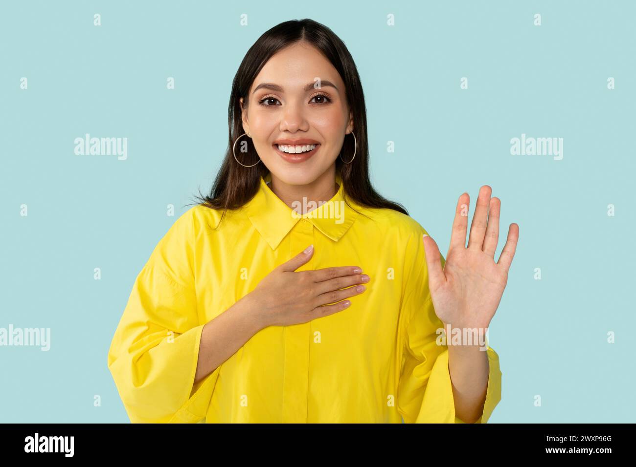 Glad sincere young woman work, raises hand, swearing an oath Stock ...