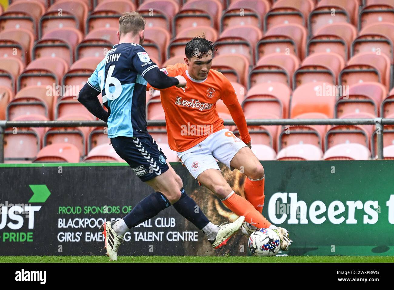 Kyle Joseph of Blackpool makes a break with the ball takes on Jason ...