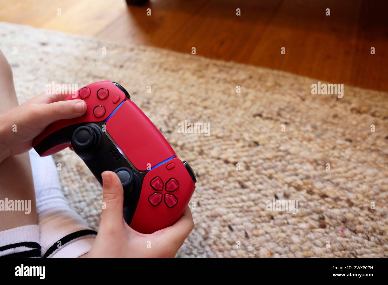 Child playing video games with controller indoors, closeup. Space for ...