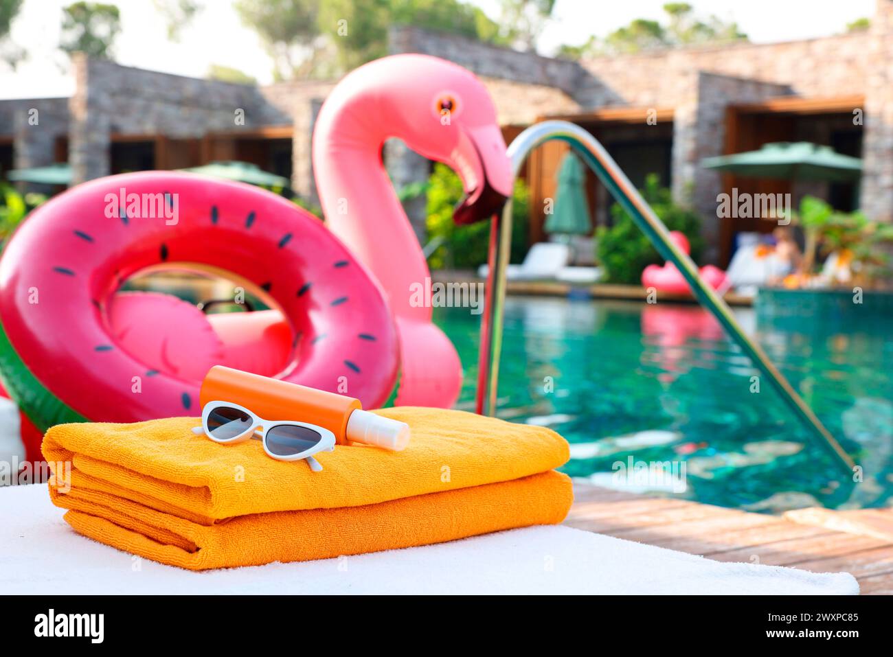 Beach accessories on sun lounger, inflatable ring and float near ...