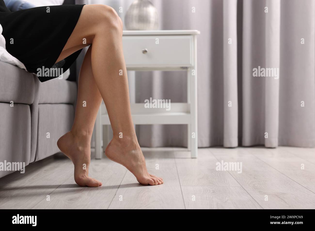 Barefoot woman in bedroom, closeup. Space for text Stock Photo - Alamy