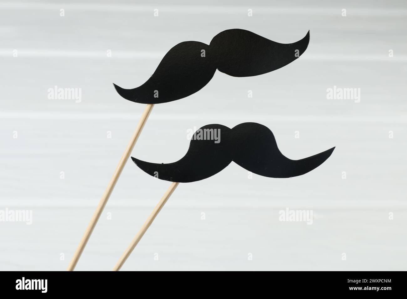 Fake paper mustaches party props on white background Stock Photo - Alamy