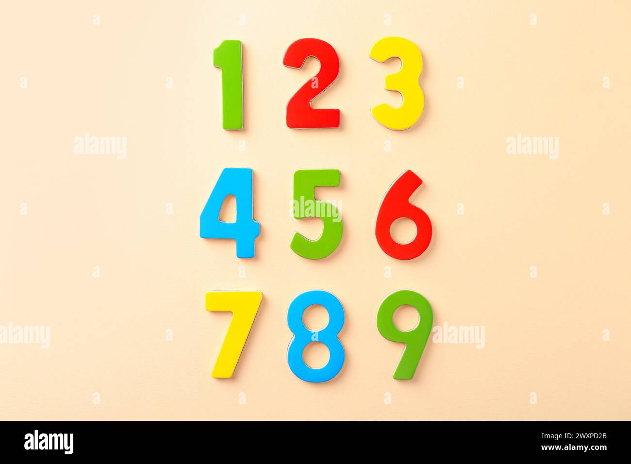 Colorful numbers on beige background, flat lay Stock Photo - Alamy