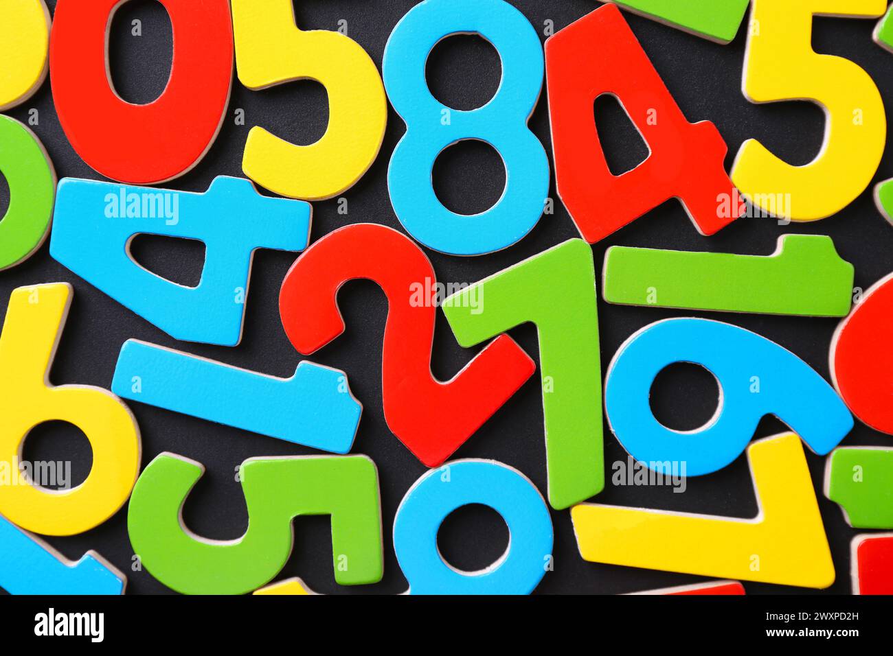 Colorful numbers on black background, top view Stock Photo - Alamy