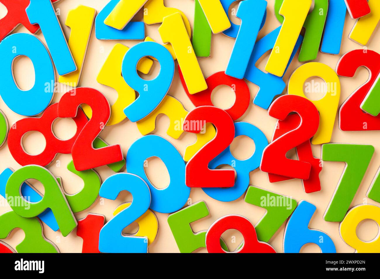 Colorful numbers on beige background, flat lay Stock Photo - Alamy