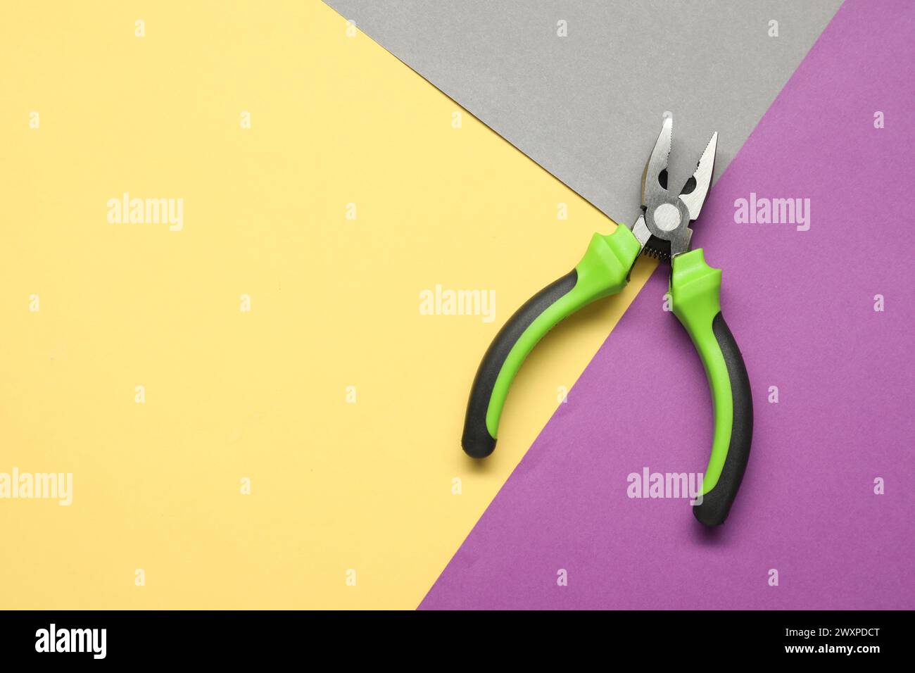 Combination pliers on color background, top view. Space for text Stock ...