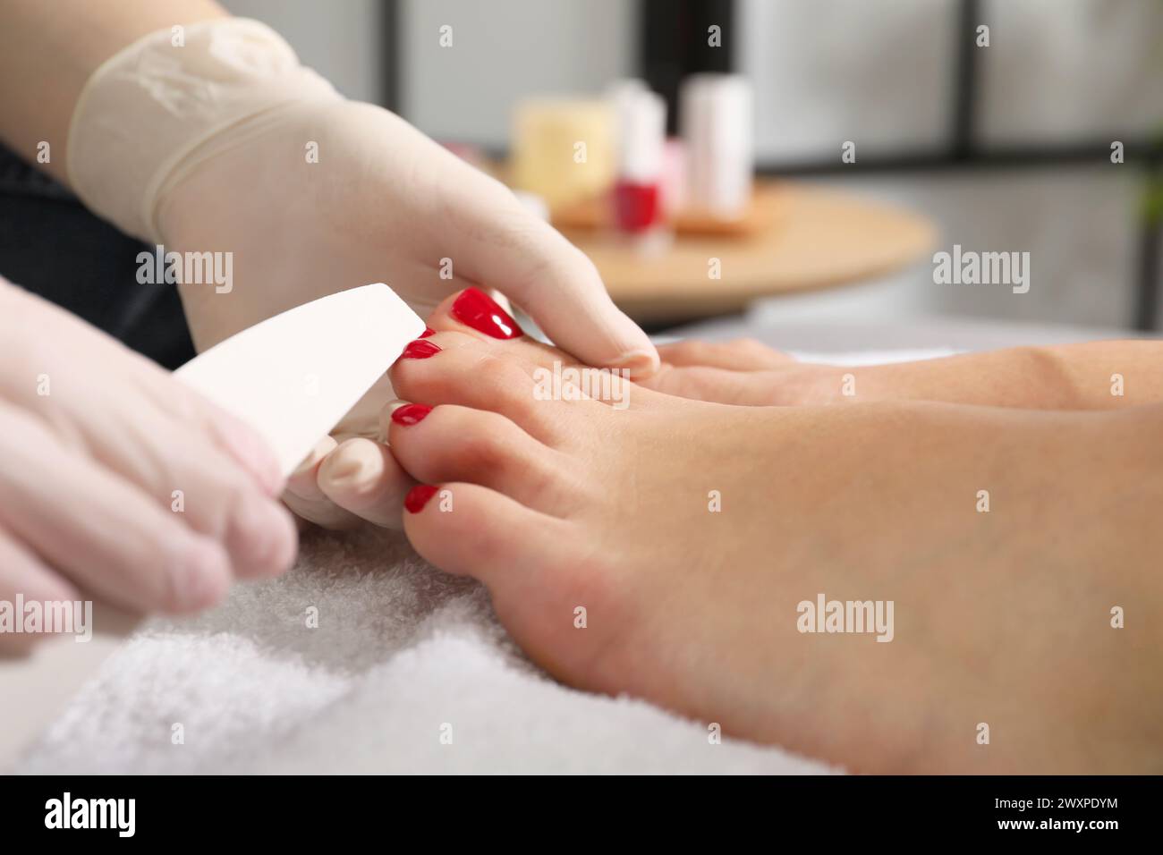 Pedicurist filing client`s toenails in beauty salon, closeup Stock ...