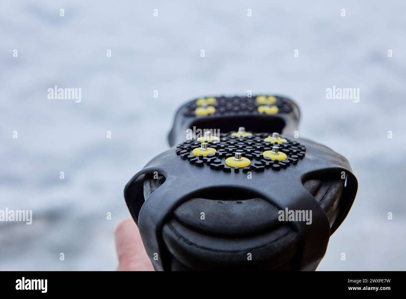 Traction on sidewalks of this over footwear rubber pad is provided by ...