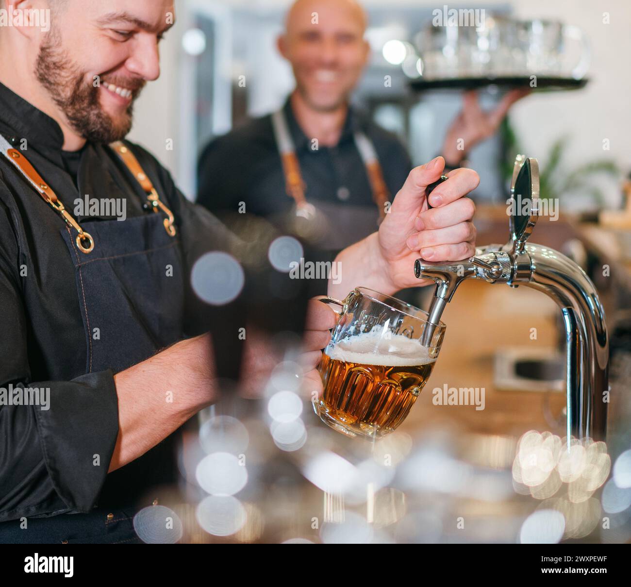 Two men friends barman and waiter with tray dressed black uniform at ...