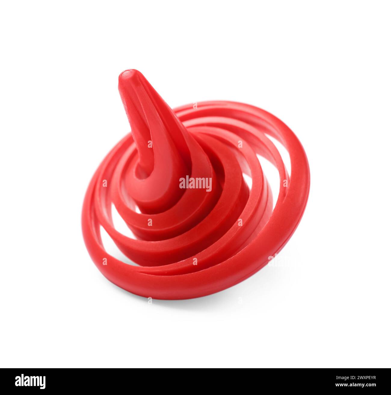 One red spinning top on white background Stock Photo - Alamy