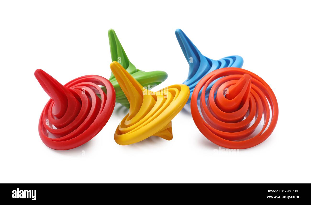 Many colorful spinning tops on white background Stock Photo - Alamy