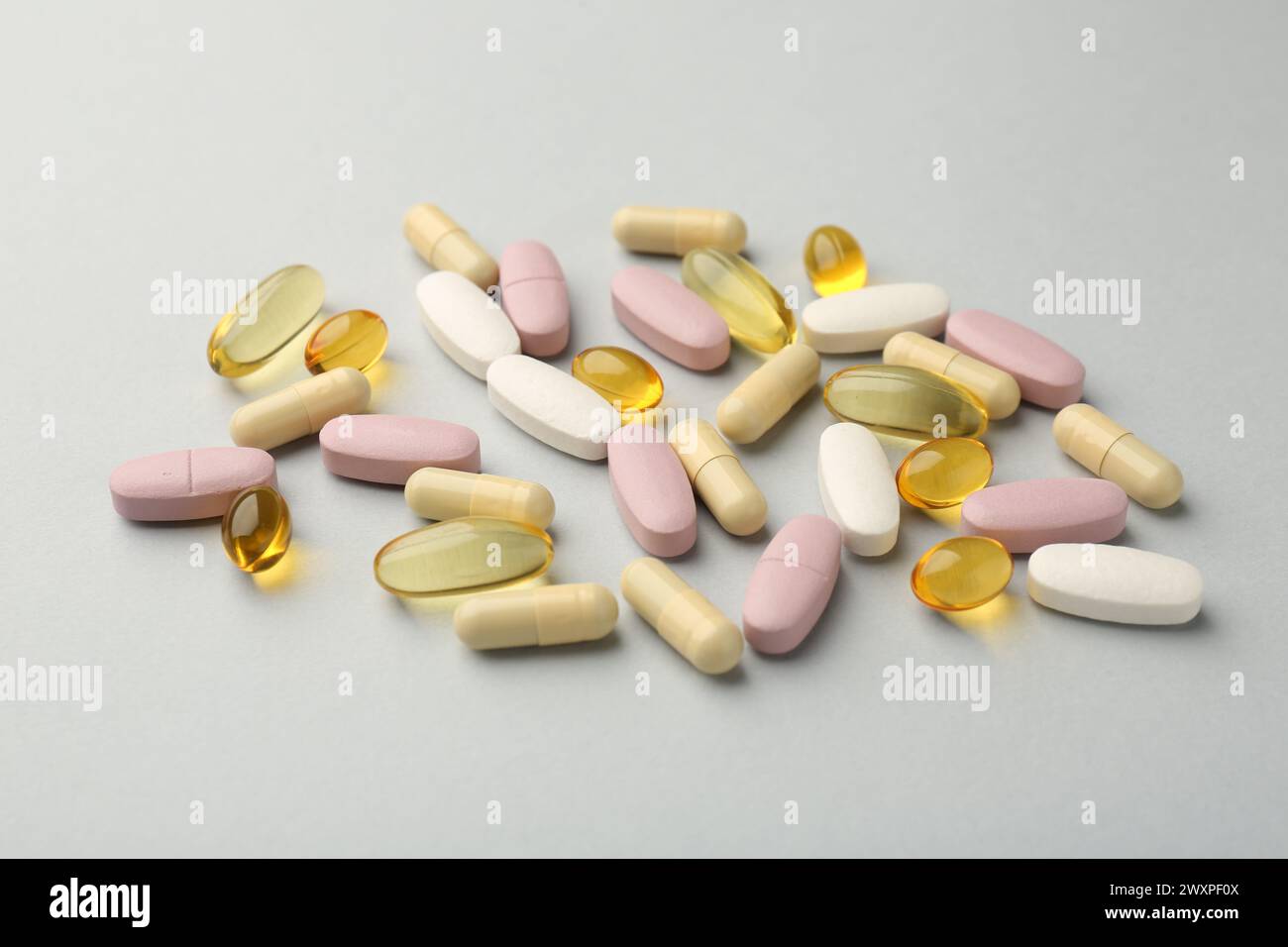 Different vitamin pills on light grey background. Health supplement ...
