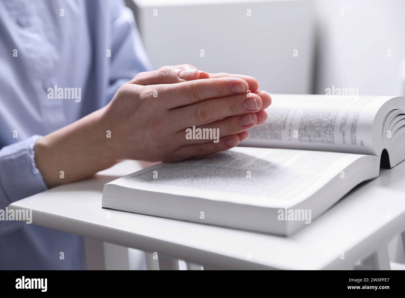 Religion. Christian woman praying over Bible indoors, closeup Stock ...