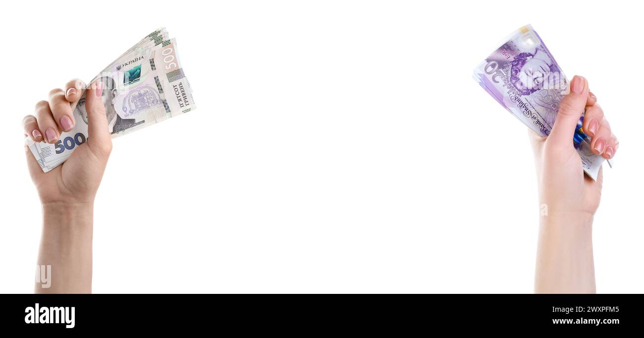 Hands with hryvnia and pound sterling banknotes on white background ...