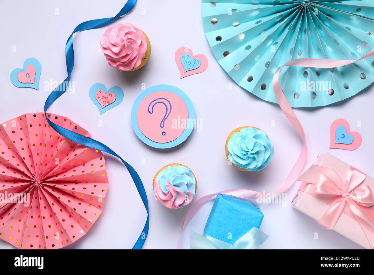 Delicious cupcakes with question marks, gift boxes and decorations on ...