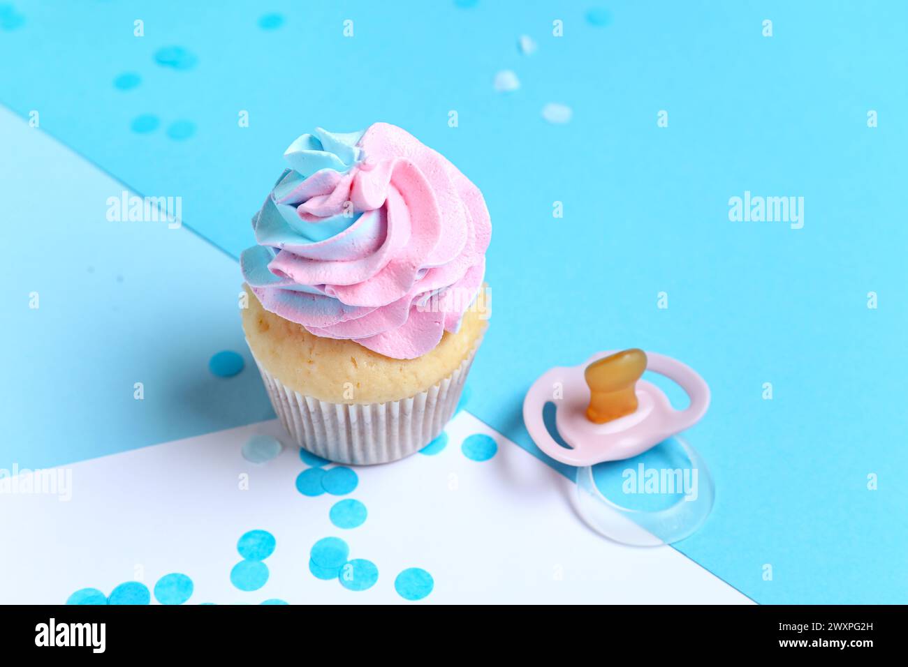 Delicious cupcake with confetti and pacifier on blue background. Gender ...