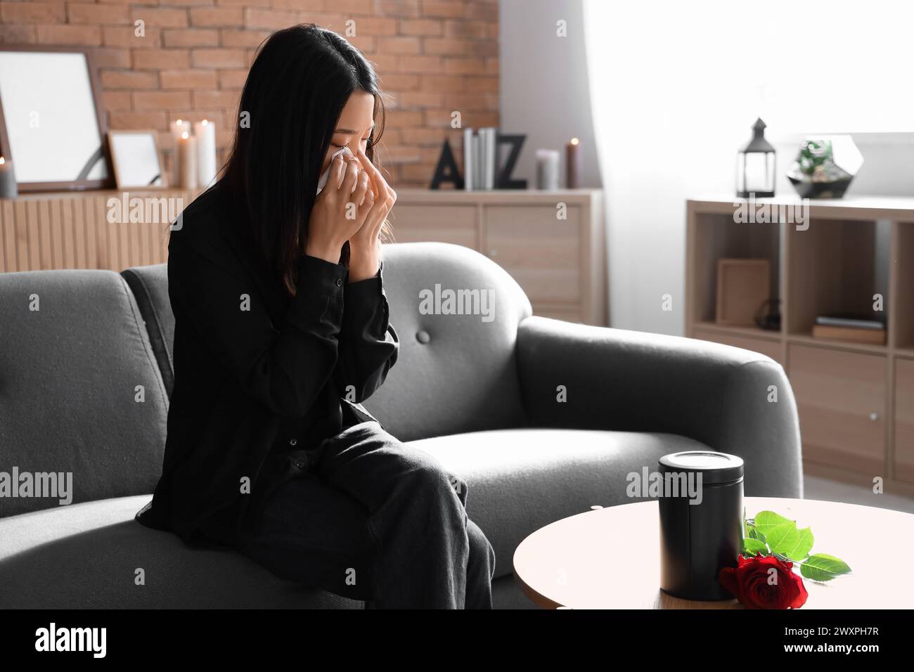 Grieving young Asian woman crying at funeral Stock Photo - Alamy