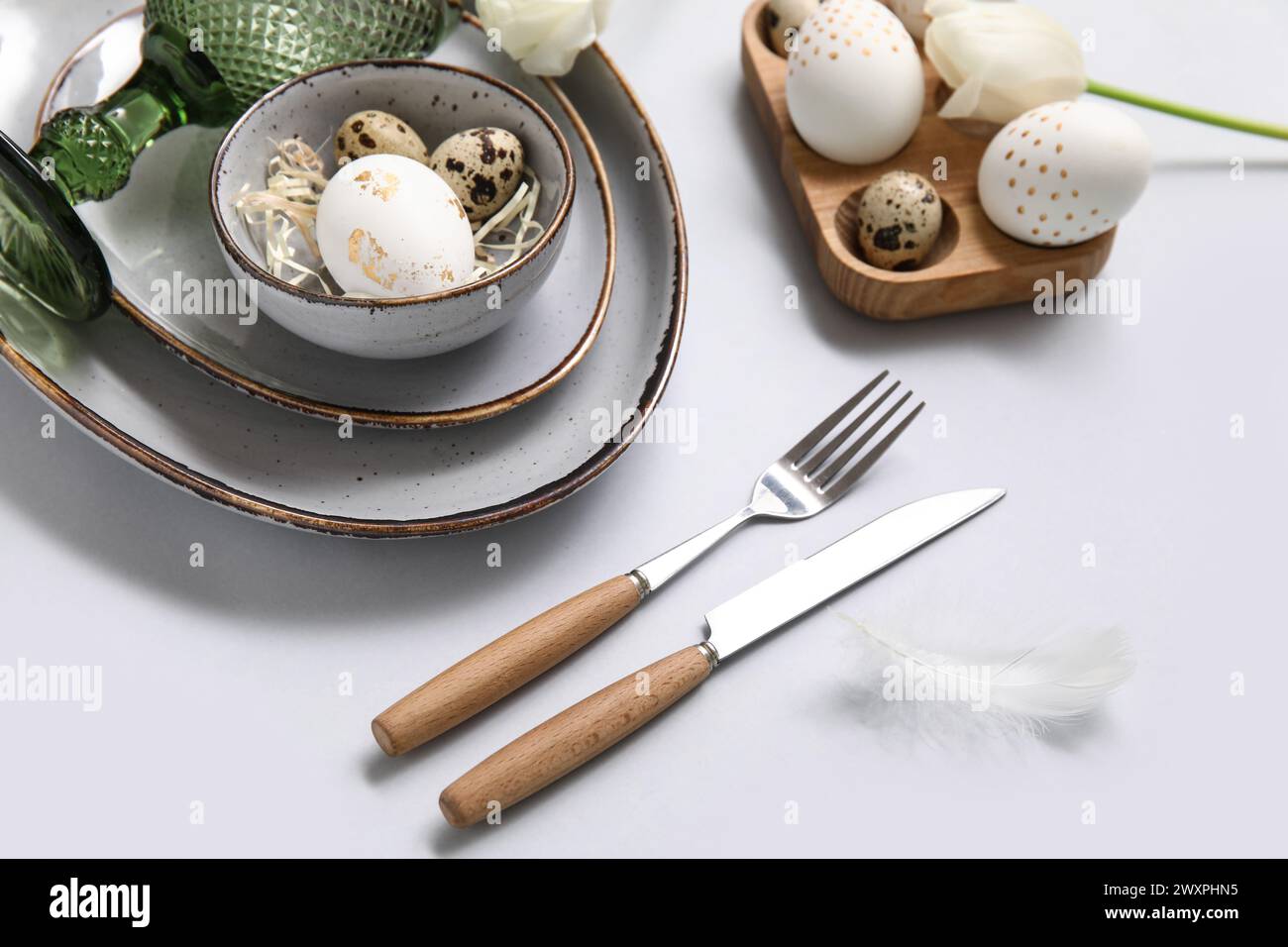 Stylish cute table setting for Easter celebration on grey background ...