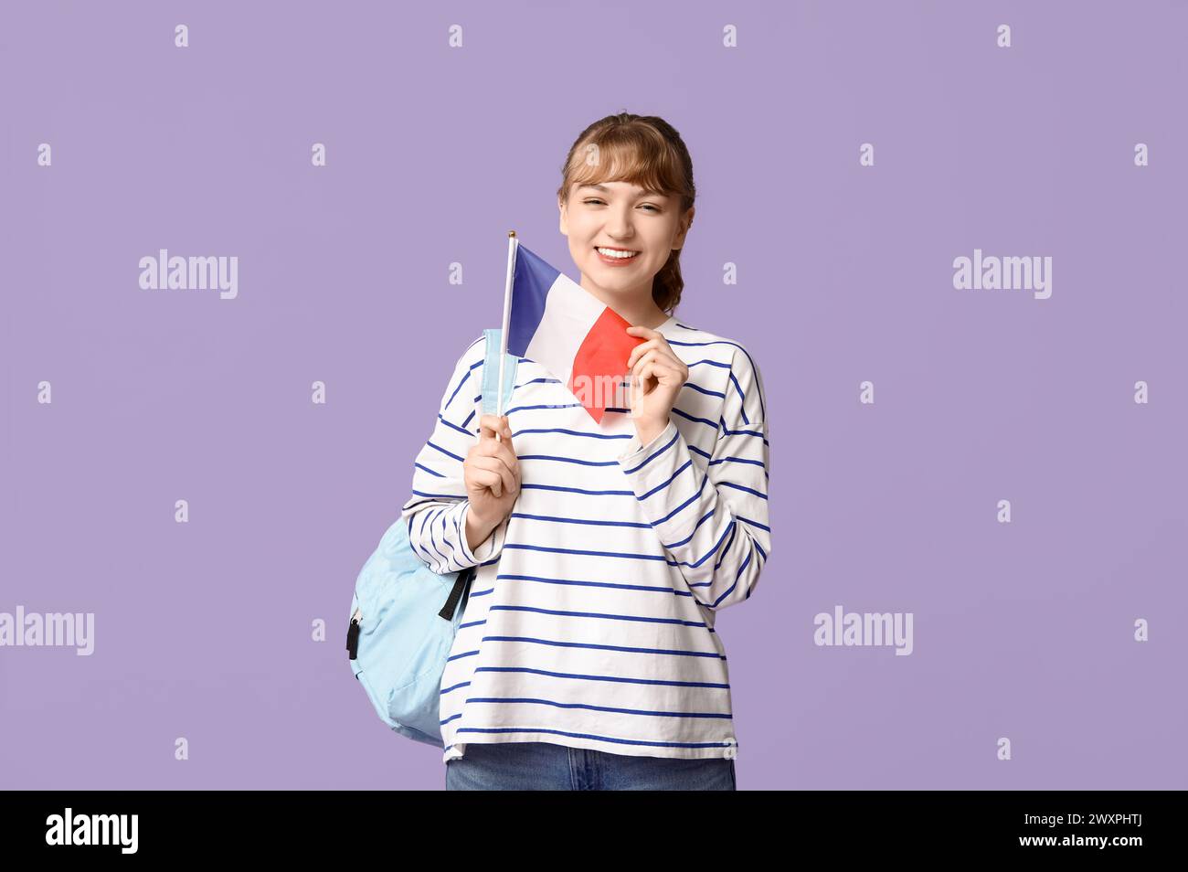 Female student with French flag on lilac background Stock Photo - Alamy