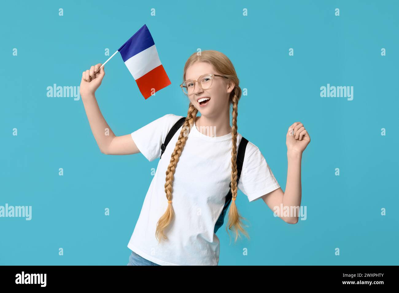 Female student with French flag on blue background Stock Photo - Alamy