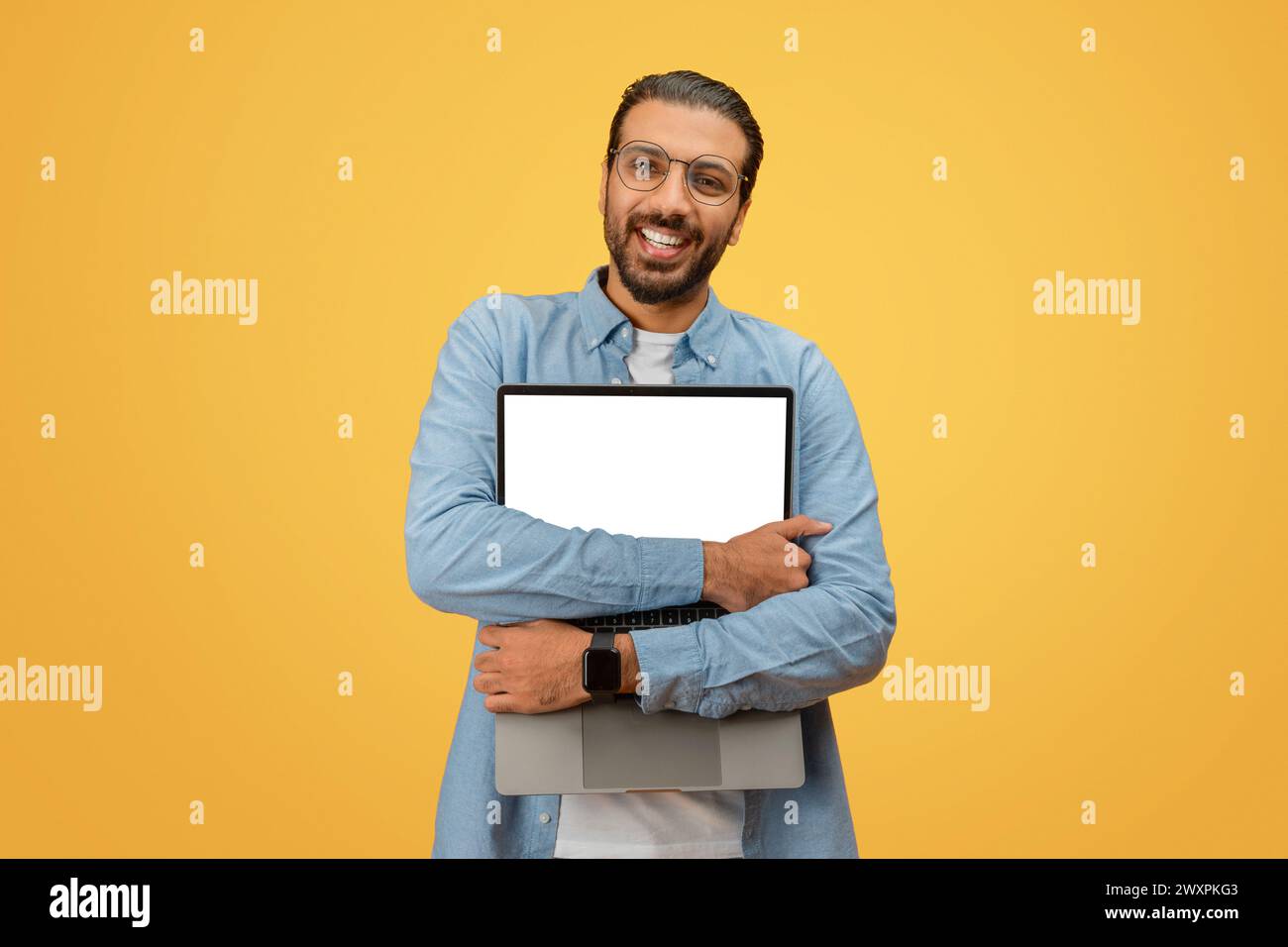 Man hugging laptop with blank screen Stock Photo - Alamy
