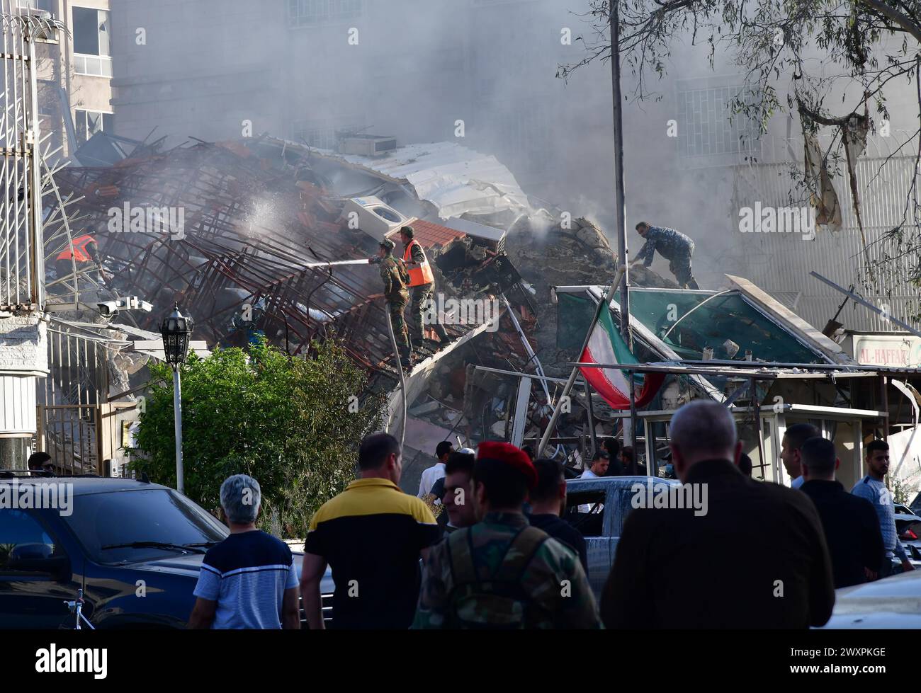 Damascus, Syria. 1st Apr, 2024. Rescuers work at the destroyed building ...