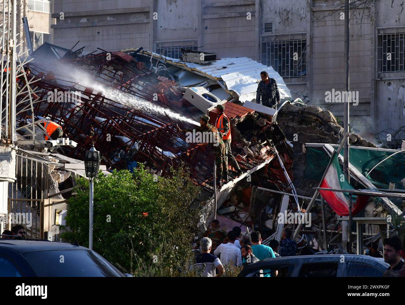 Damascus, Syria. 1st Apr, 2024. Rescuers work at the destroyed building ...