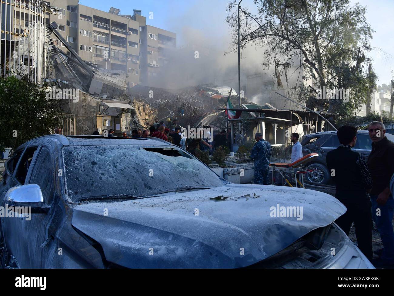 Damascus, Syria. 1st Apr, 2024. Rescuers work near the destroyed ...
