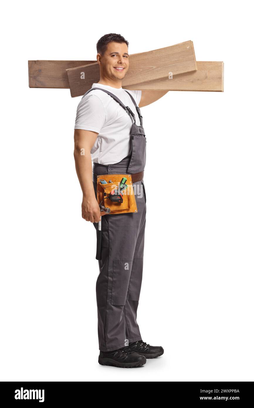 Full length shot of a carpenter holding wooden beams isolated on white ...