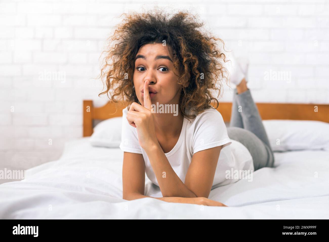 Happy black woman showing silence hi-res stock photography and images ...