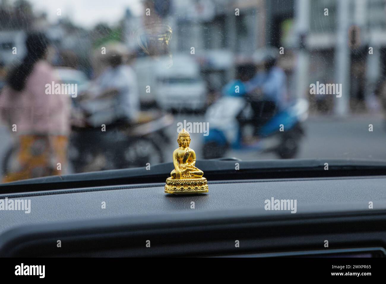 Buddha figurine on the hood of a car. tuk tuk driver in sri lanka ...