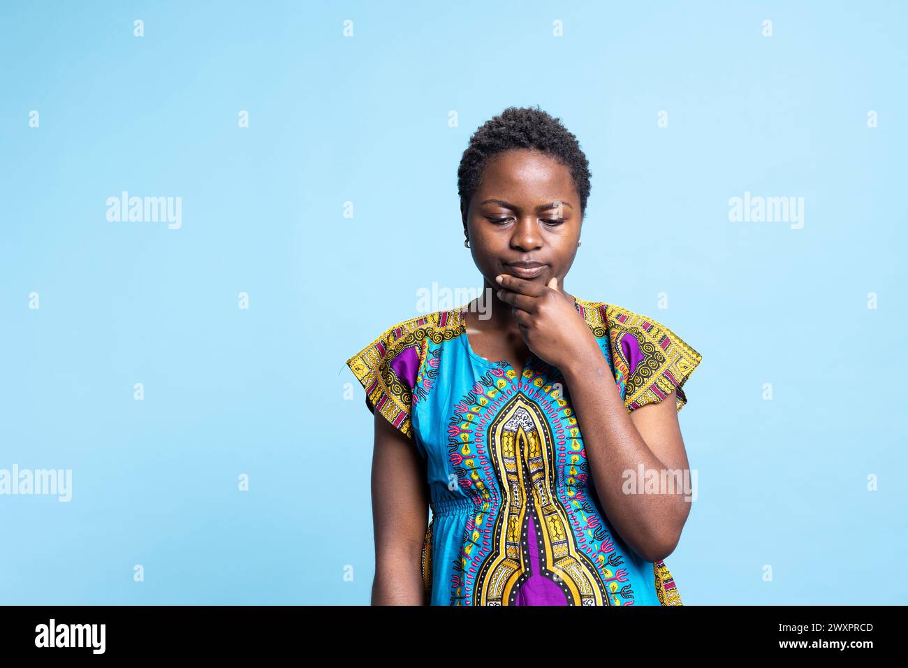 Serious female model posing with a meditative facial expression ...