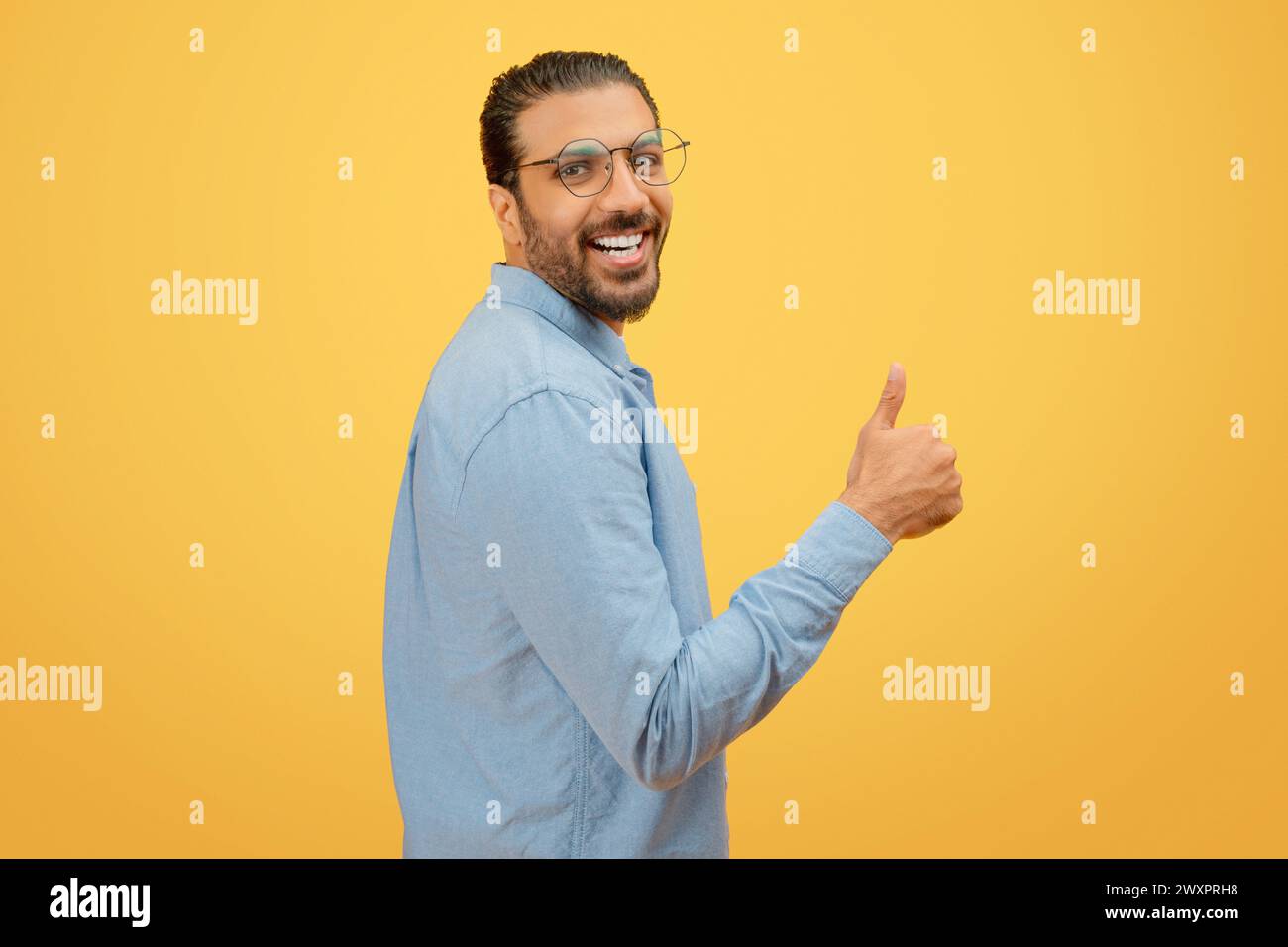 Man giving a thumbs up with a cheerful expression Stock Photo - Alamy